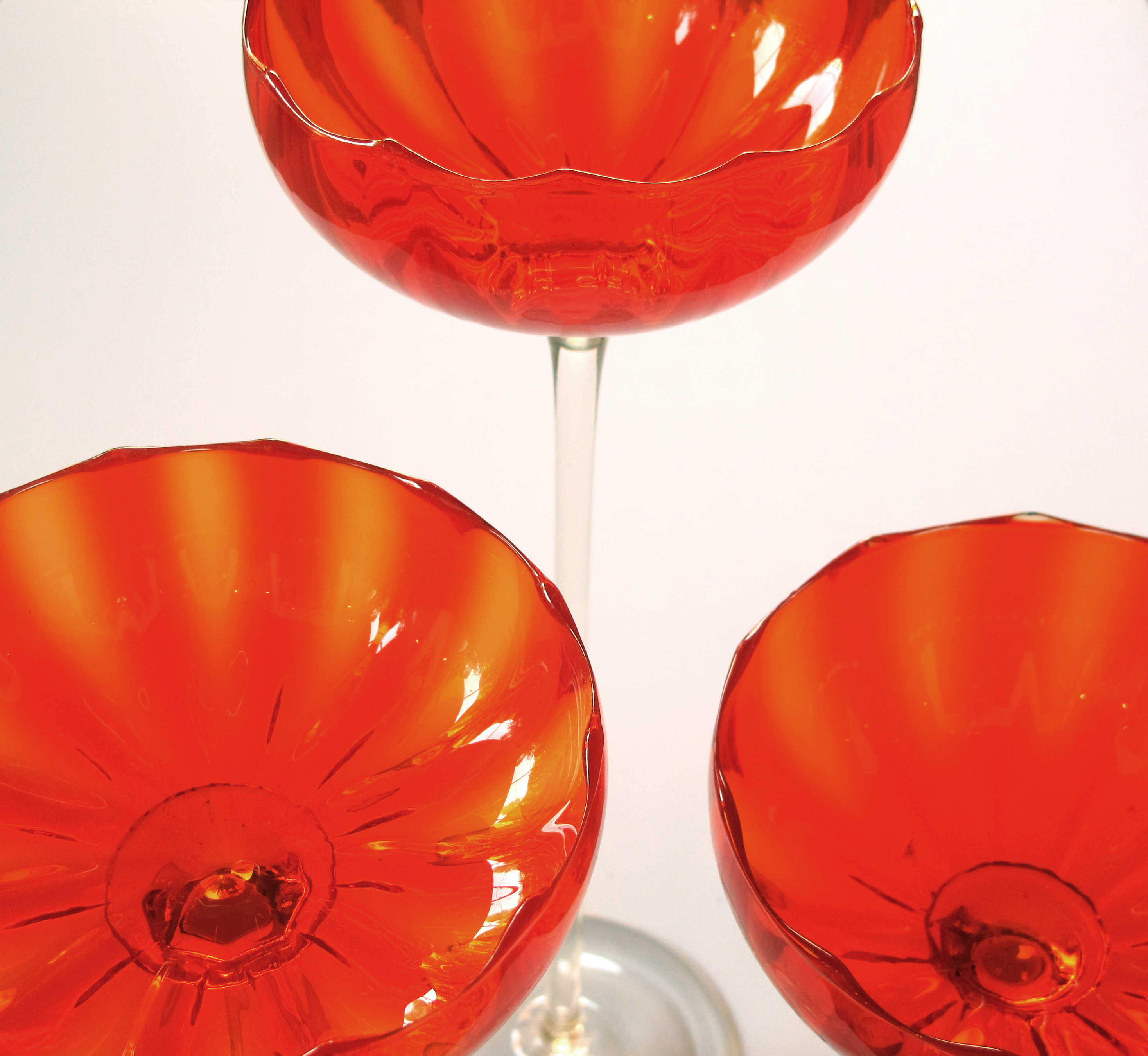 a vibrant set of 3 murano 1960's orange glass compotes on clear glass ...